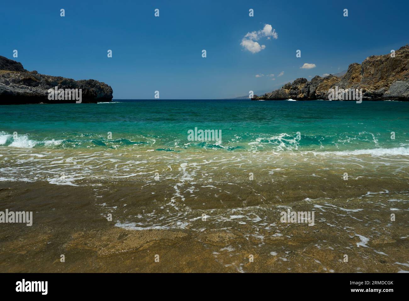A scenic beach with clear, pristine water and rolling waves Stock Photo ...
