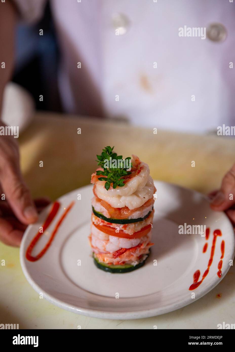 Chef prepared shrimp and crab tower serving his dish Stock Photo - Alamy