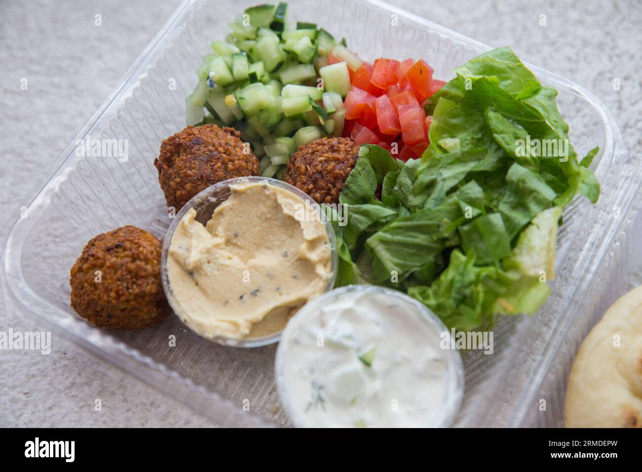 To Go Falafel Set with tzatziki and a salad Stock Photo - Alamy