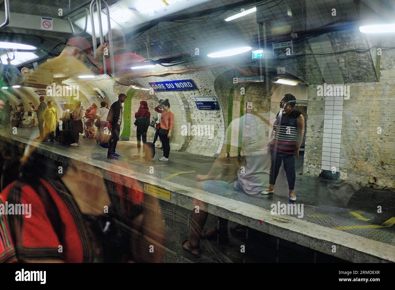 Reflections in a Metro train window, looking out at Gare Du Nord ...