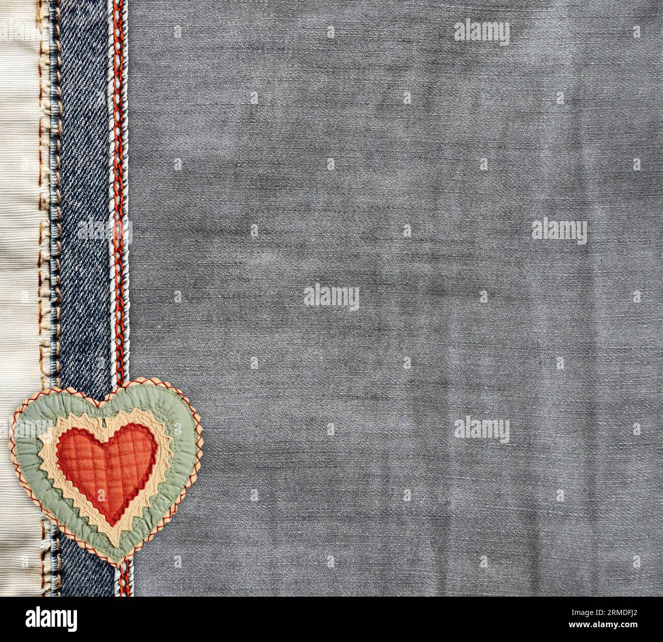 Grey and light grey denim background with a seam and felt heart. Light ...