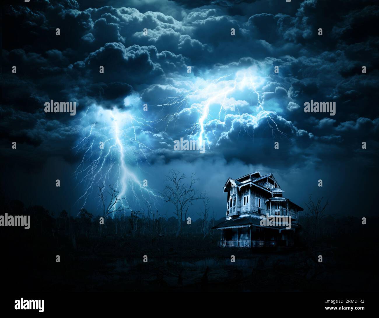 Dramatic landscape with haunted house and stormy sky with lightnings ...