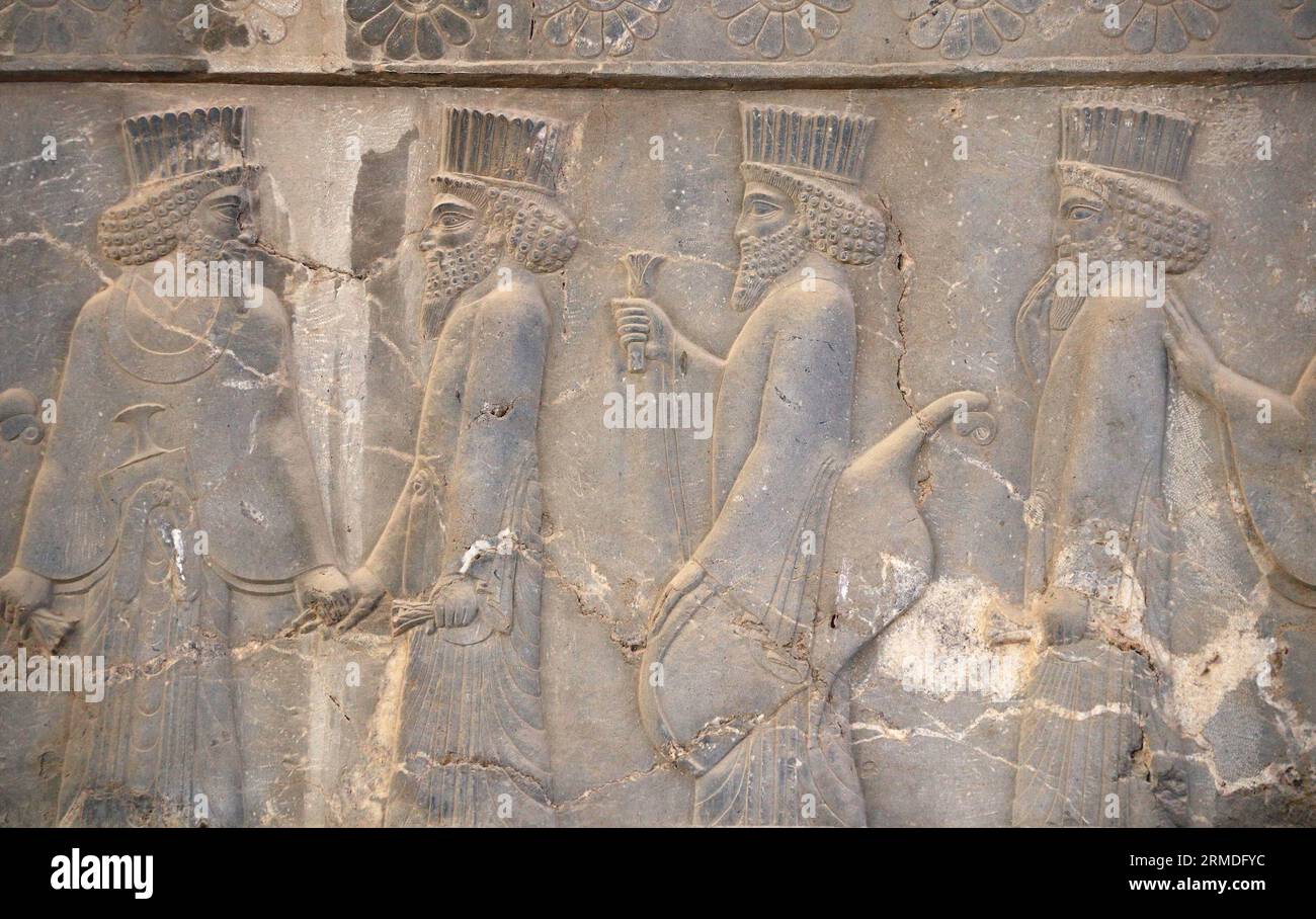 Ancient wall with bas-relief with assyrian foreign ambassadors with ...