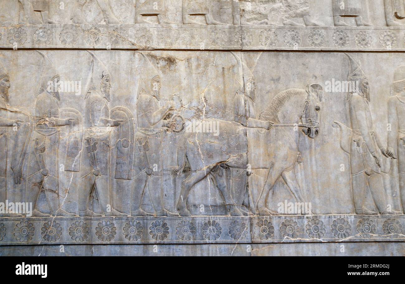 Ancient wall with bas-relief with assyrian foreign ambassadors with ...