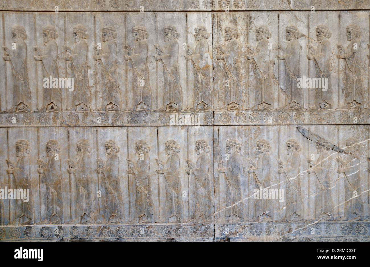 Ancient wall with bas-relief with assyrian warriors with spears ...