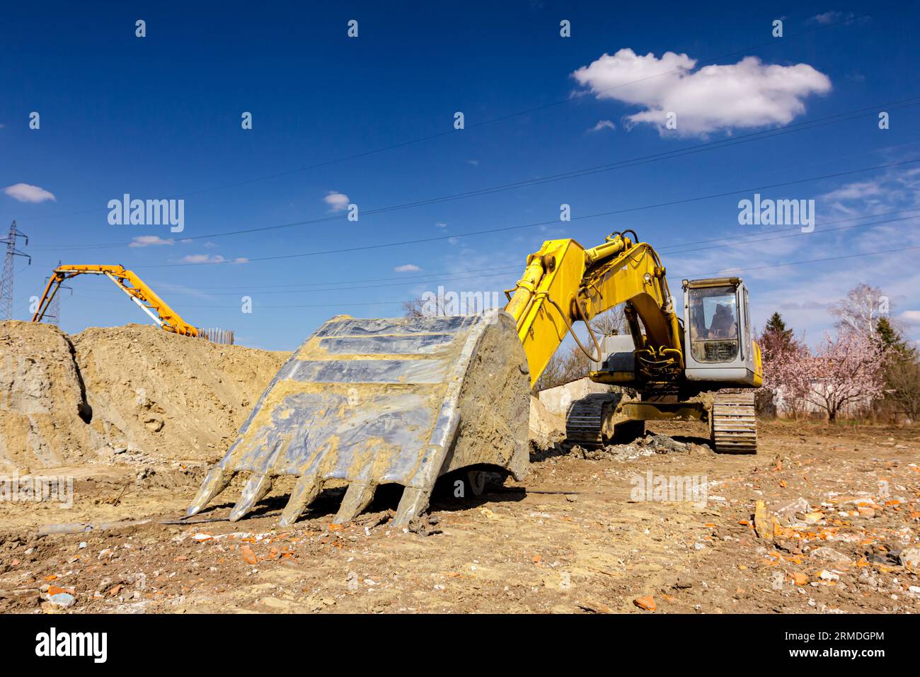 Big excavator is standing parked on ground at construction site ...