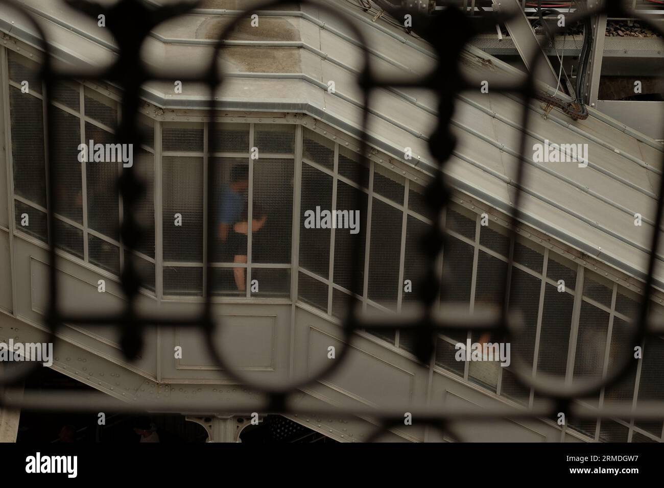 Mise en scène, looking through iron balustrade onto the steel and ...
