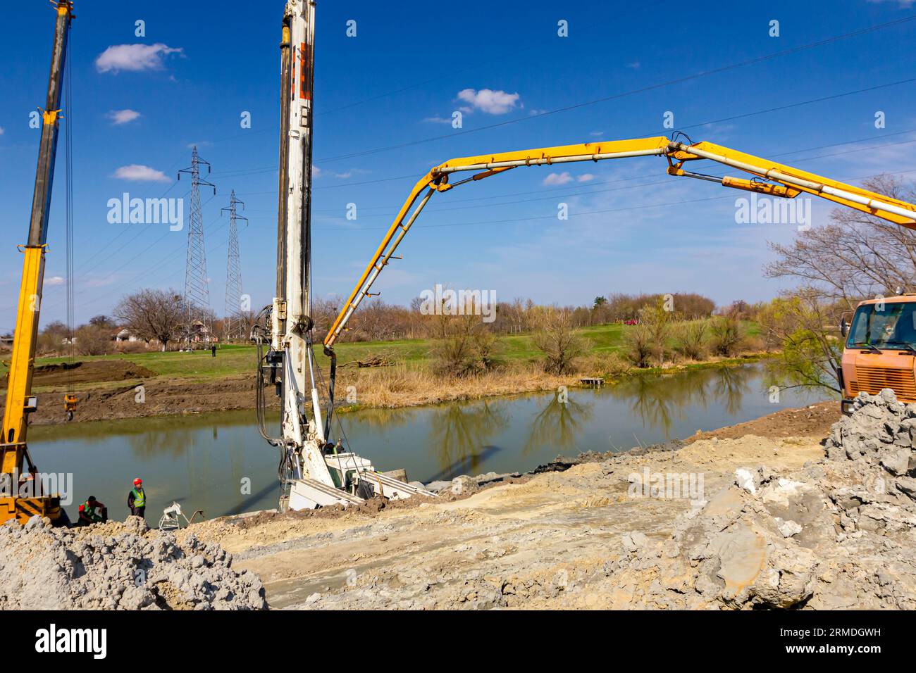 Pouring fresh concrete in bridge foundation, under construction on ...