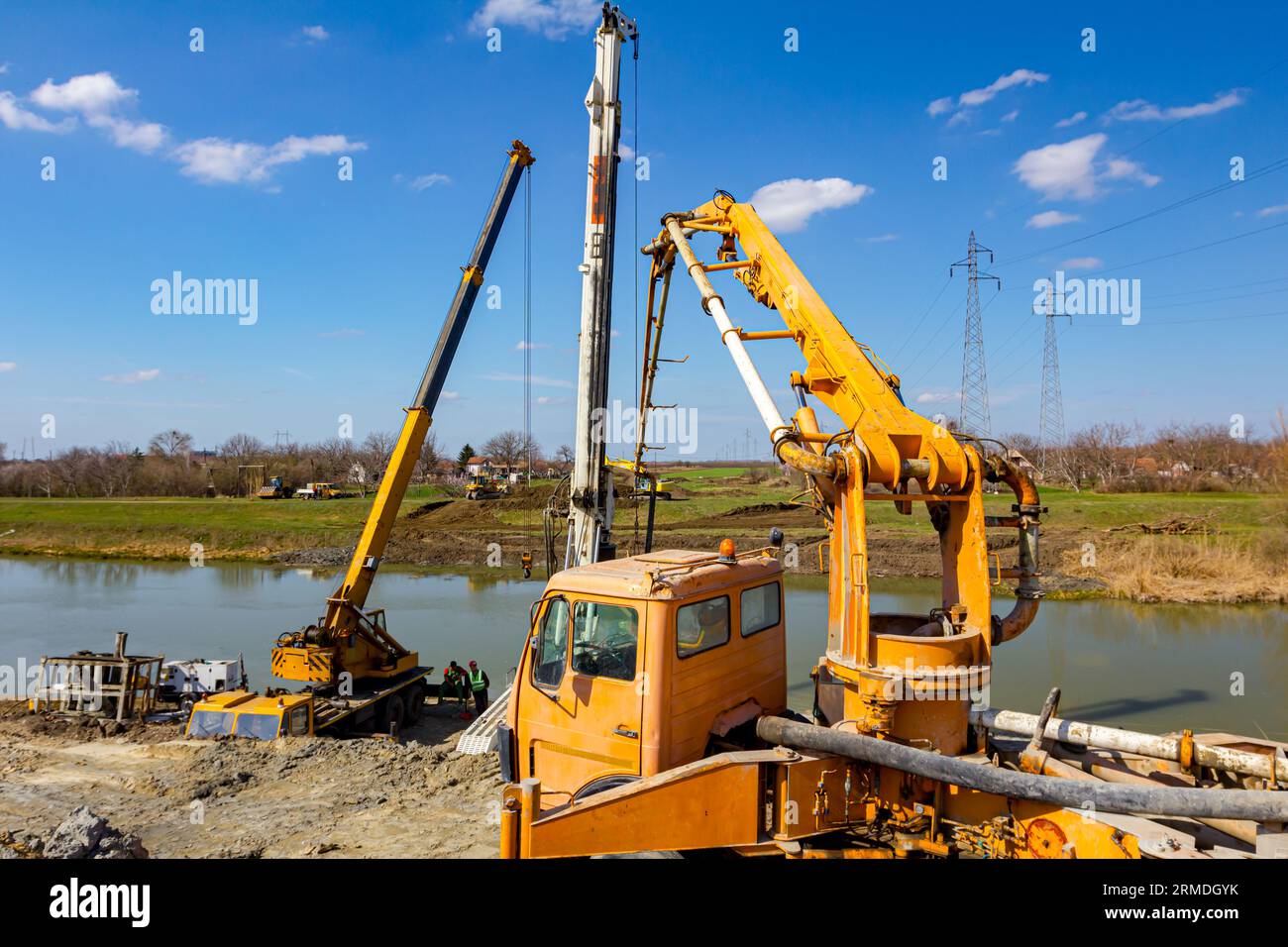Pouring fresh concrete in bridge foundation, under construction on ...