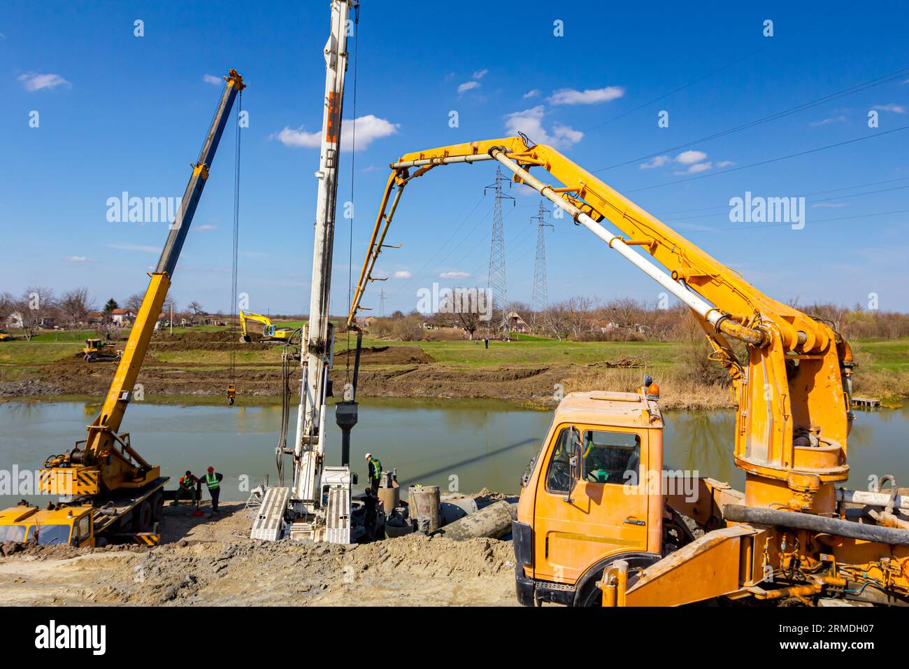 Pouring fresh concrete in bridge foundation, under construction on ...
