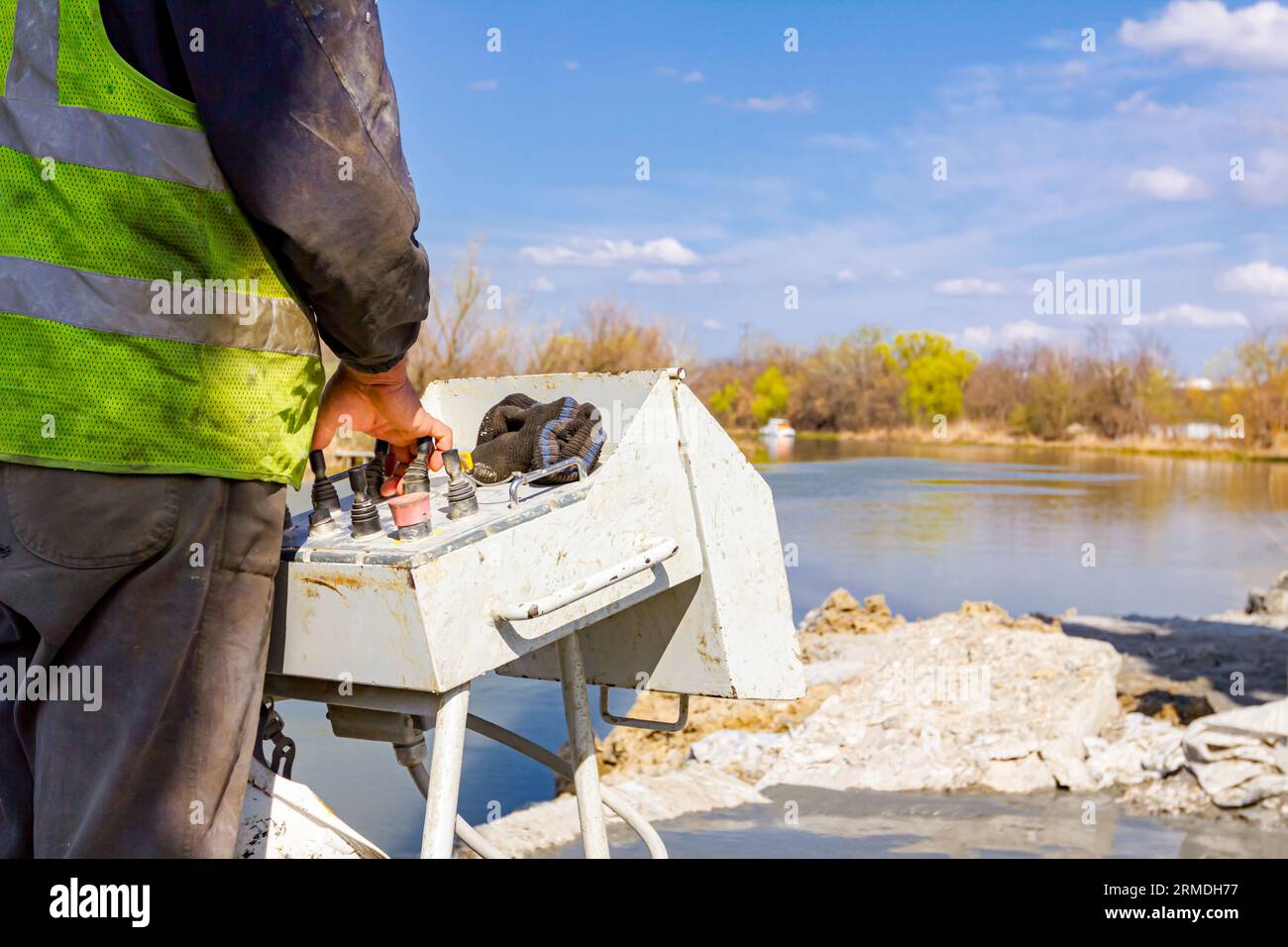 Worker is holding joystick to manage tower drilling machine, industrial ...