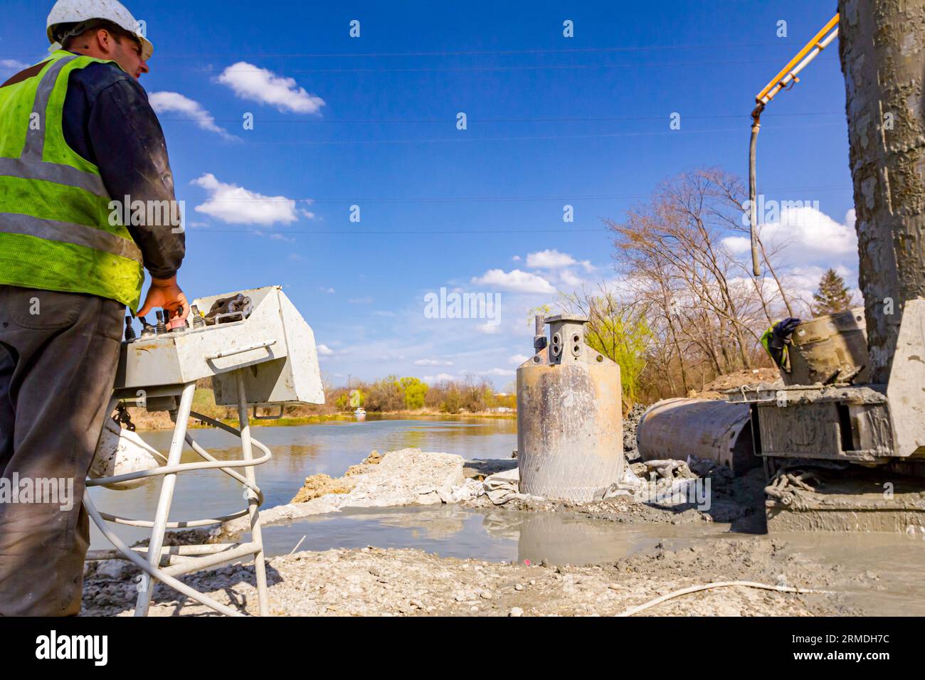 View from behind on construction worker with safety vest and white ...