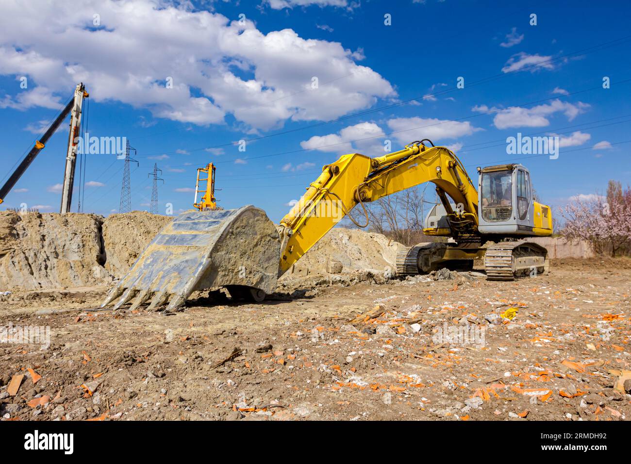 Big excavator is standing parked on ground at construction site ...