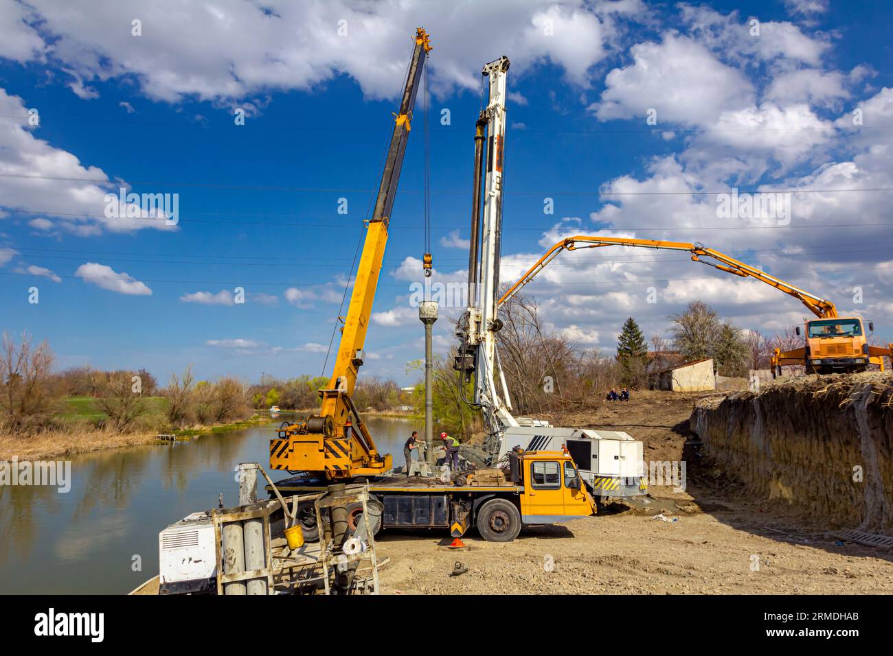 Pouring fresh concrete in bridge foundation, under construction on ...