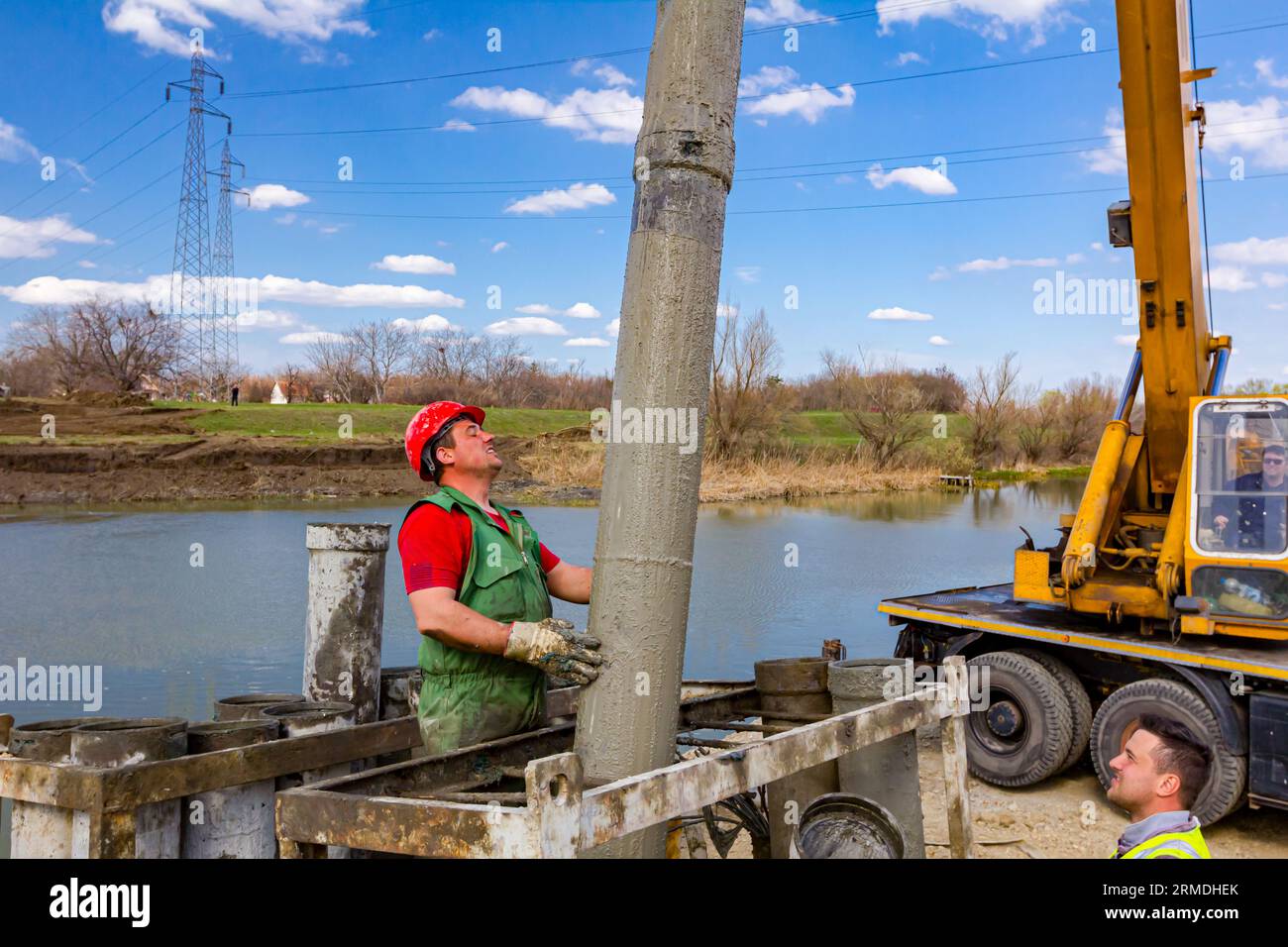 Rigger, worker with safety helmet disassembles pump canal for vertical ...