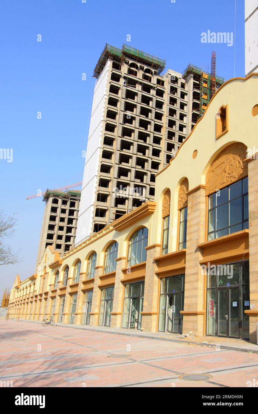 unfinished color building, under the blu sky background Stock Photo - Alamy
