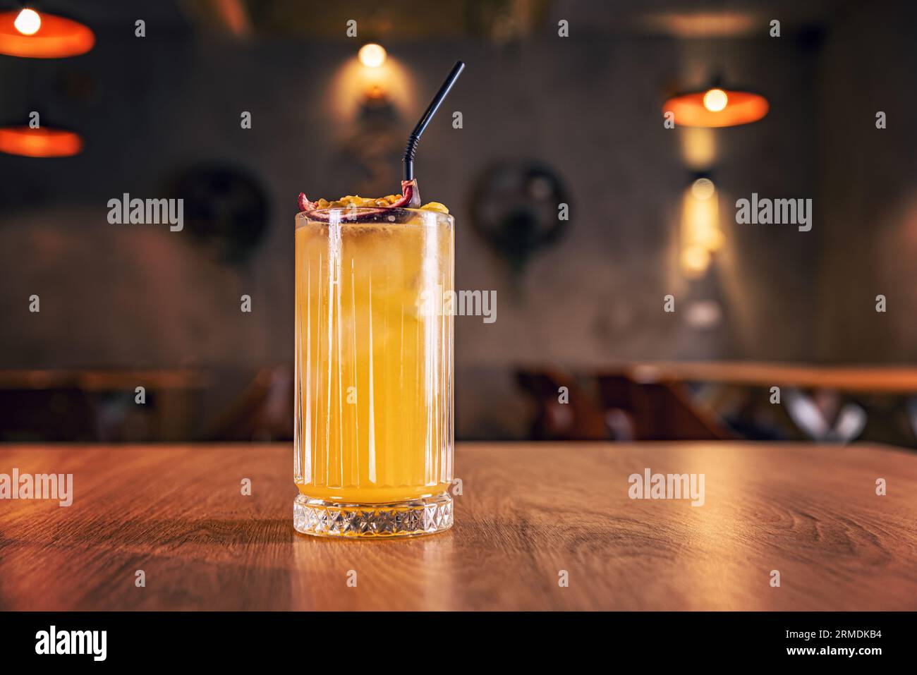 Glass of iced passion fruit soda with lemon and passion fruit half ...