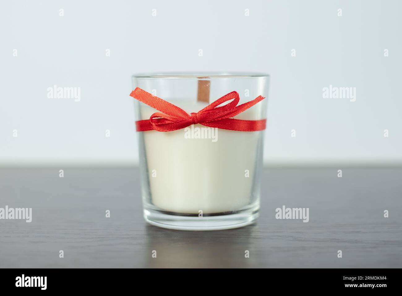 Candles with a red bow Stock Photo - Alamy