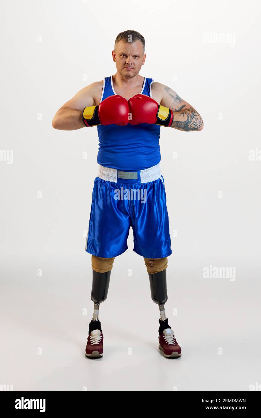 Full length of attractive positive man with prosthesis in boxing ...
