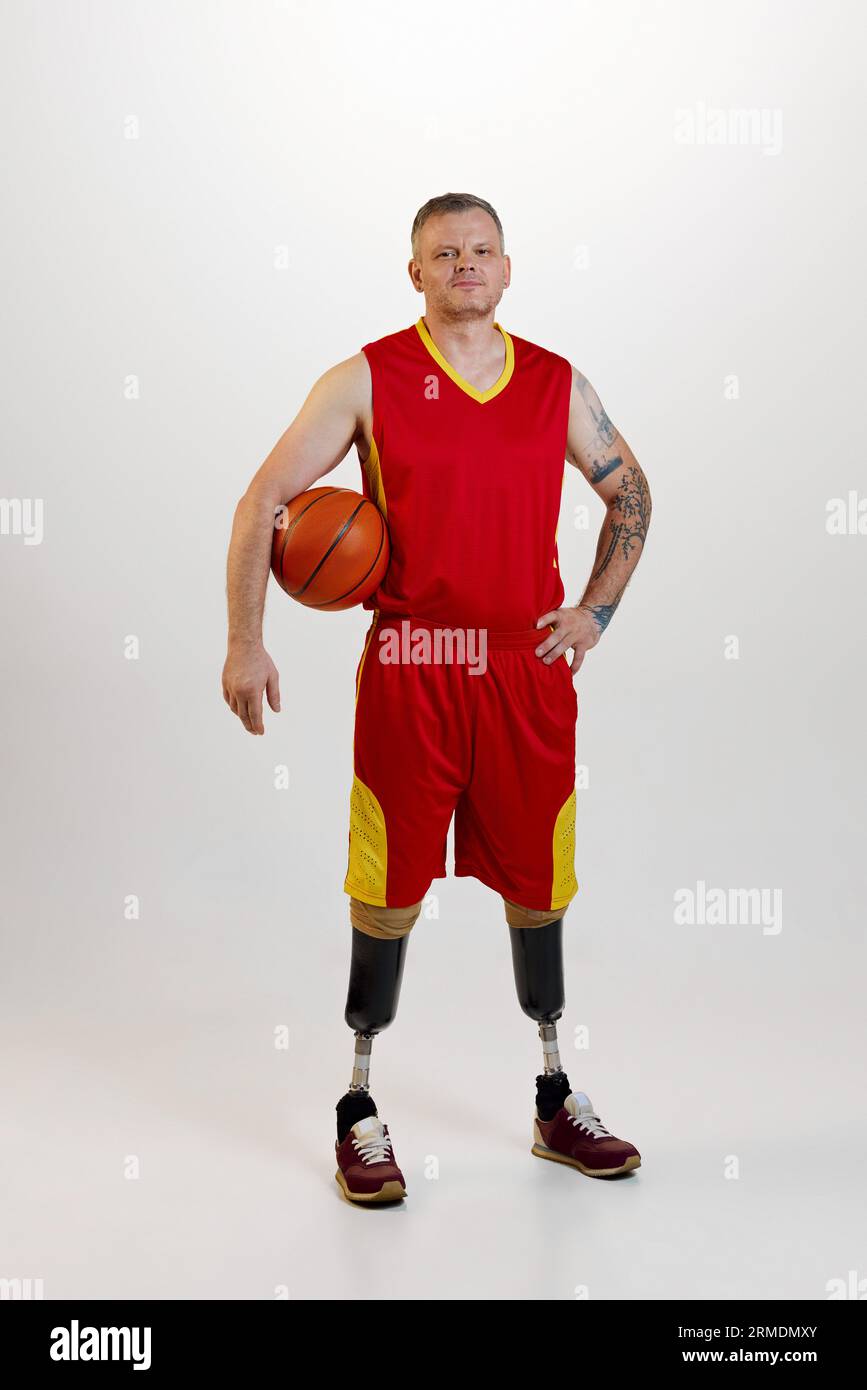 Attractive man amputee with prosthetic leg disability standing holding ...