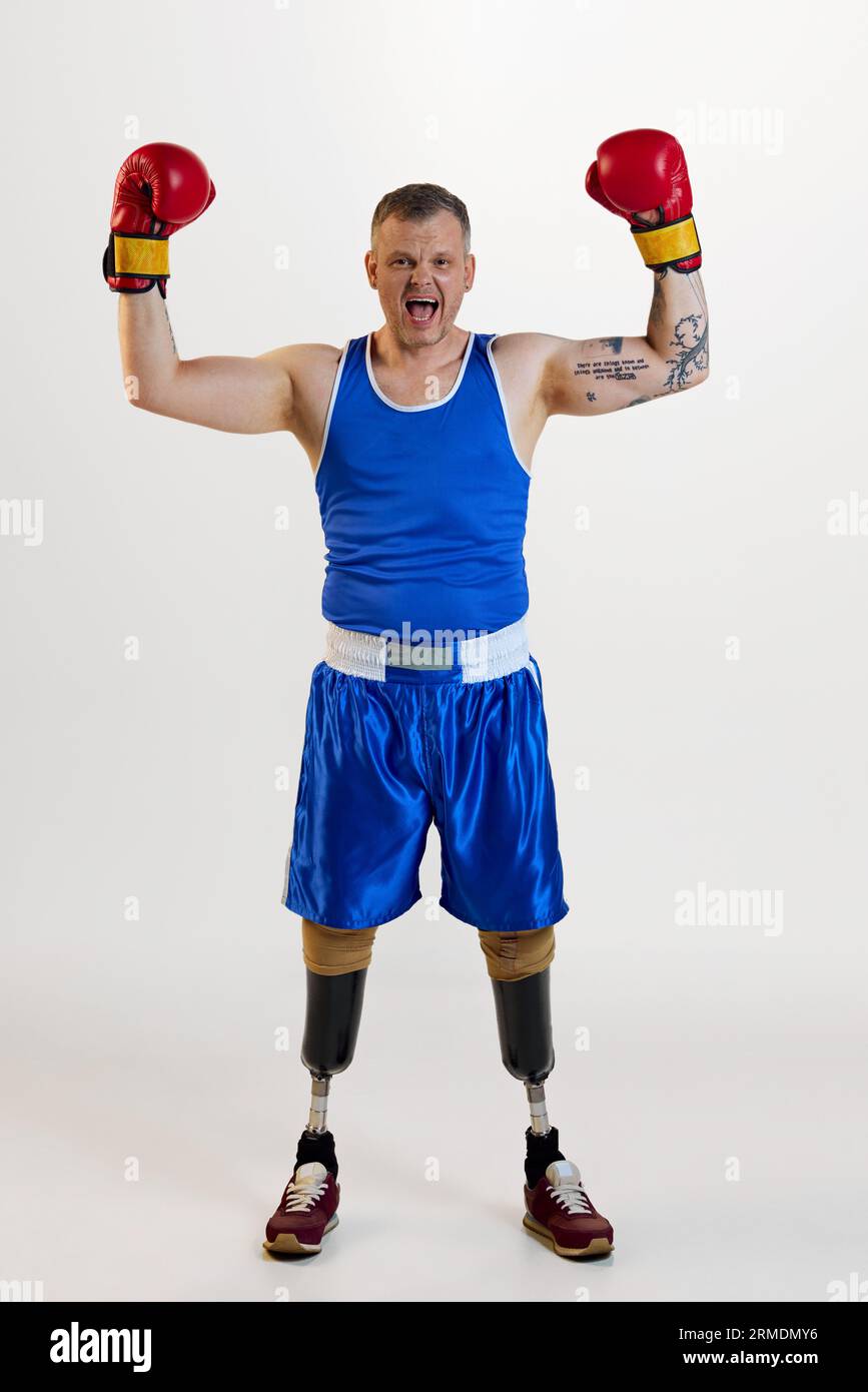 Full length of attractive confident man with prosthesis in boxing ...