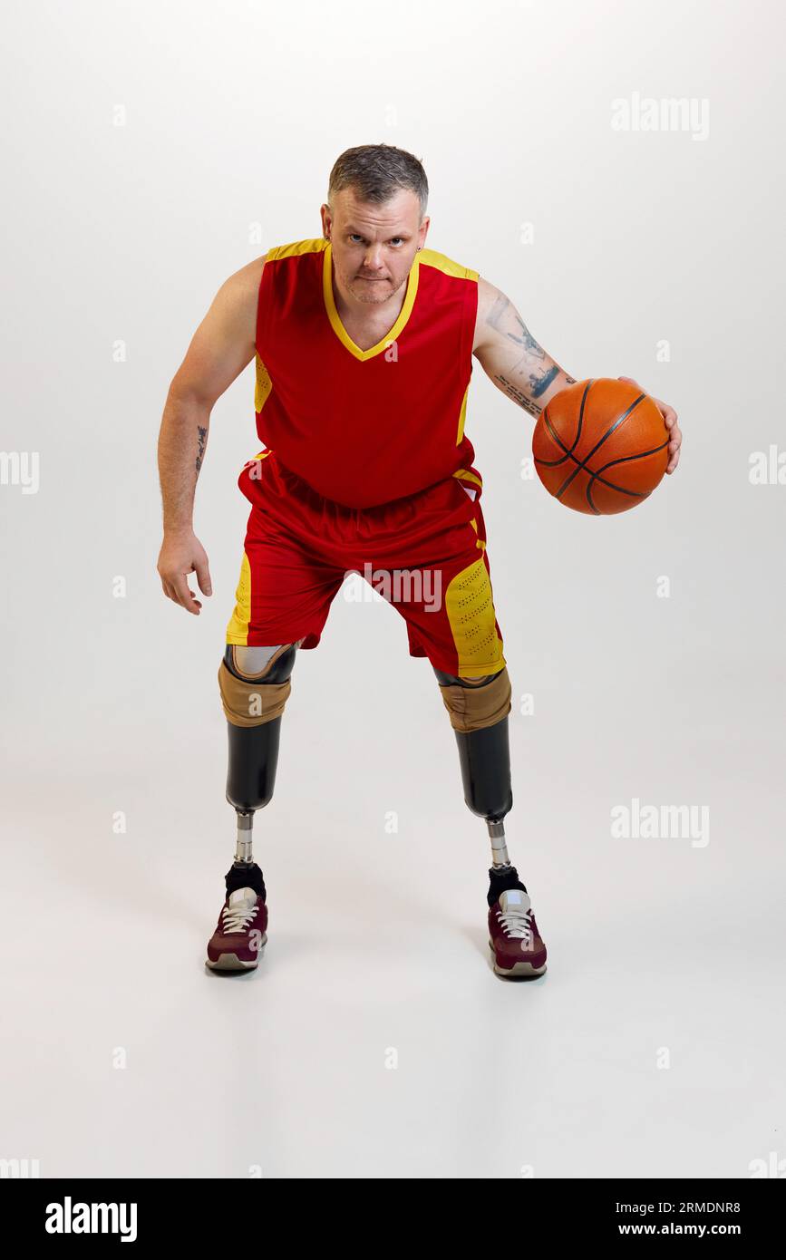 Attractive, confident man with prosthetic leg disability with orange ...