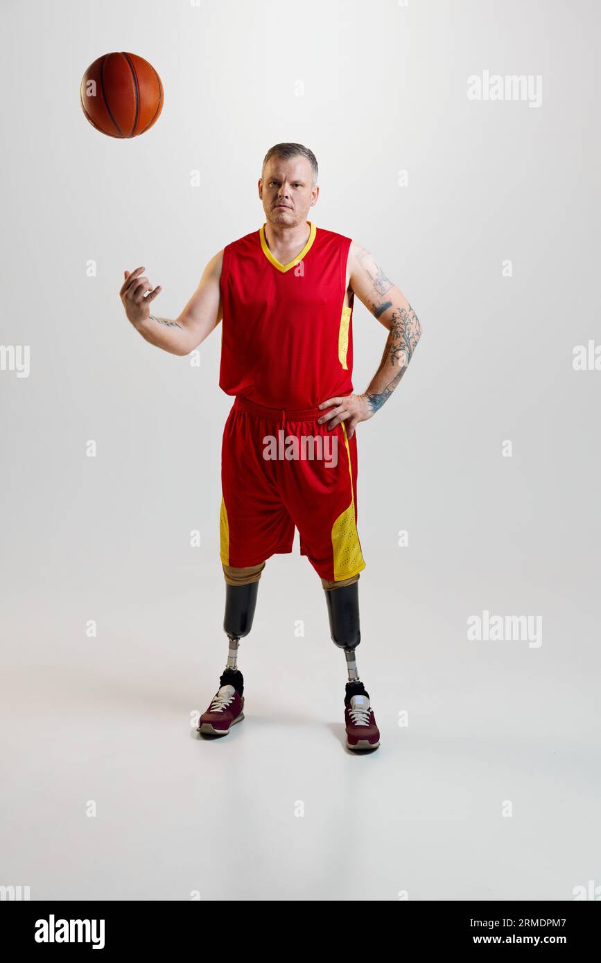 Confident, sporty man with prosthetic legs, disability in uniform ...