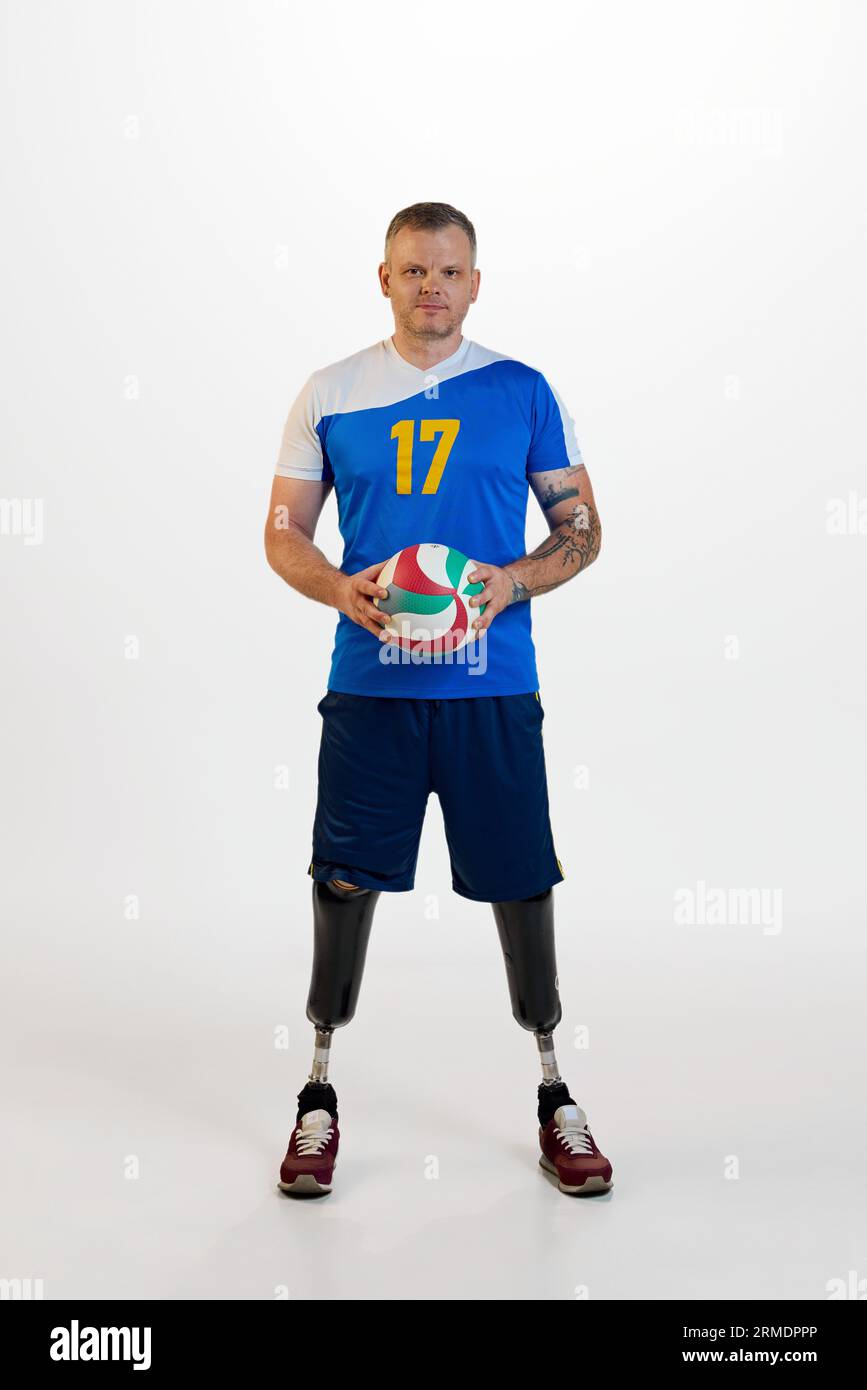 Attractive young man with prosthetic leg disability standing holding ...
