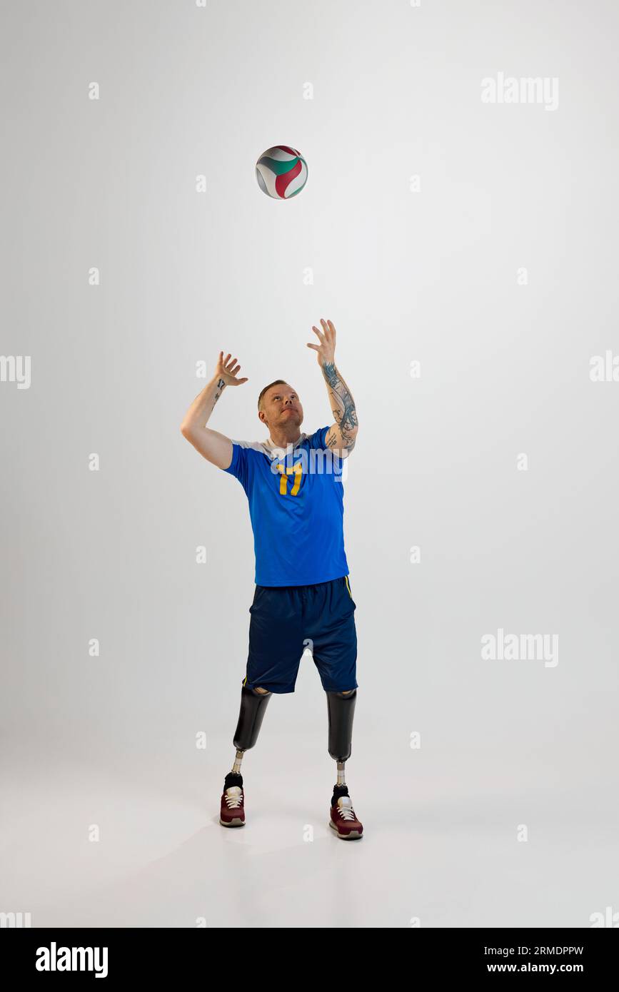 Attractive young man with prosthetic leg disability standing catching ...