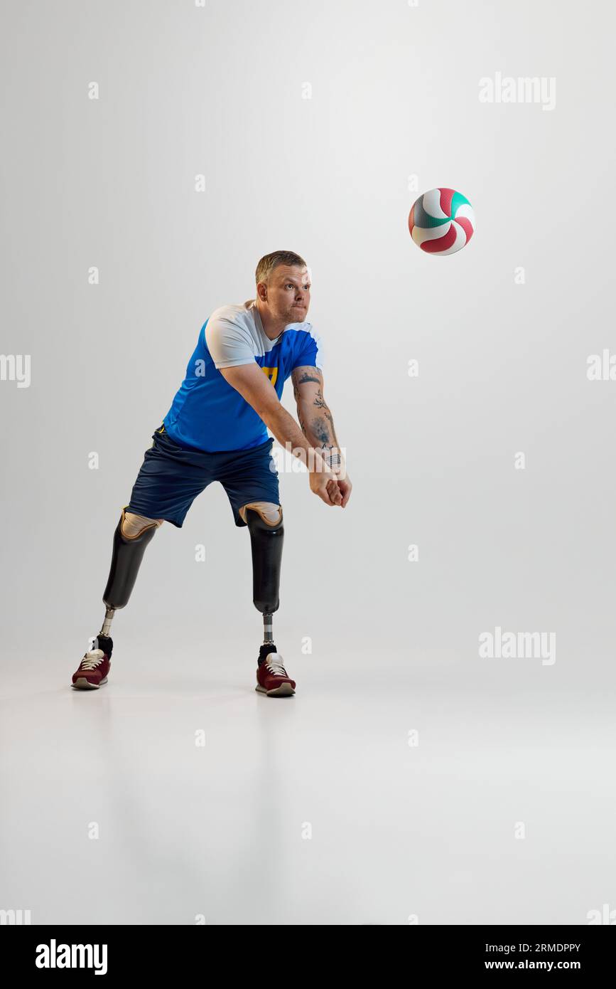 Confident young man with prosthetic legs disability standing hits ...