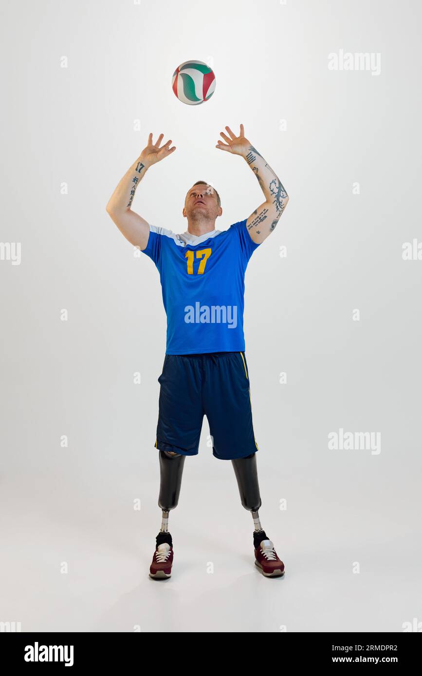 Attractive young man with prosthetic leg disability standing throws up ...