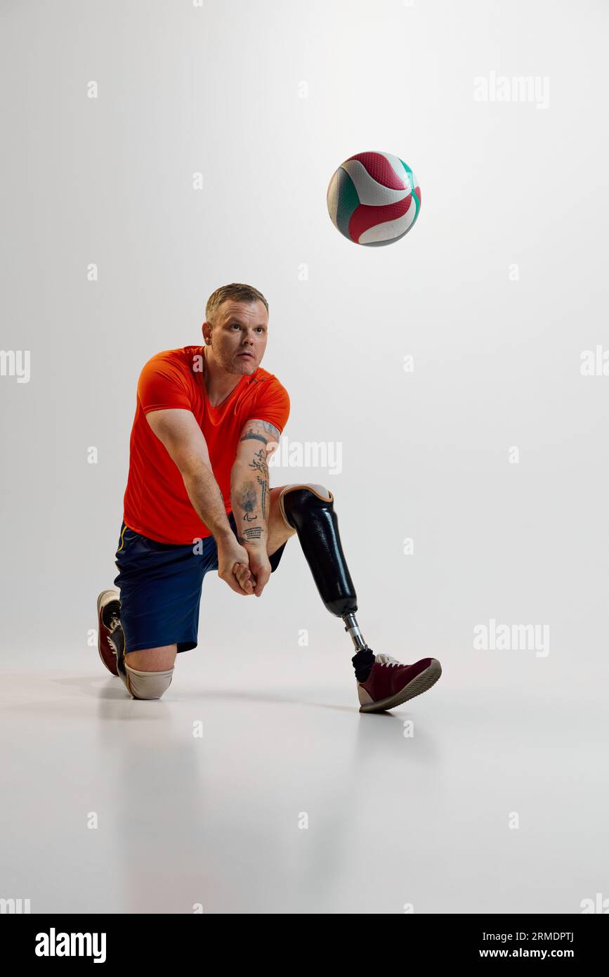 Confident man with prosthetic legs, disability in uniform hits ...