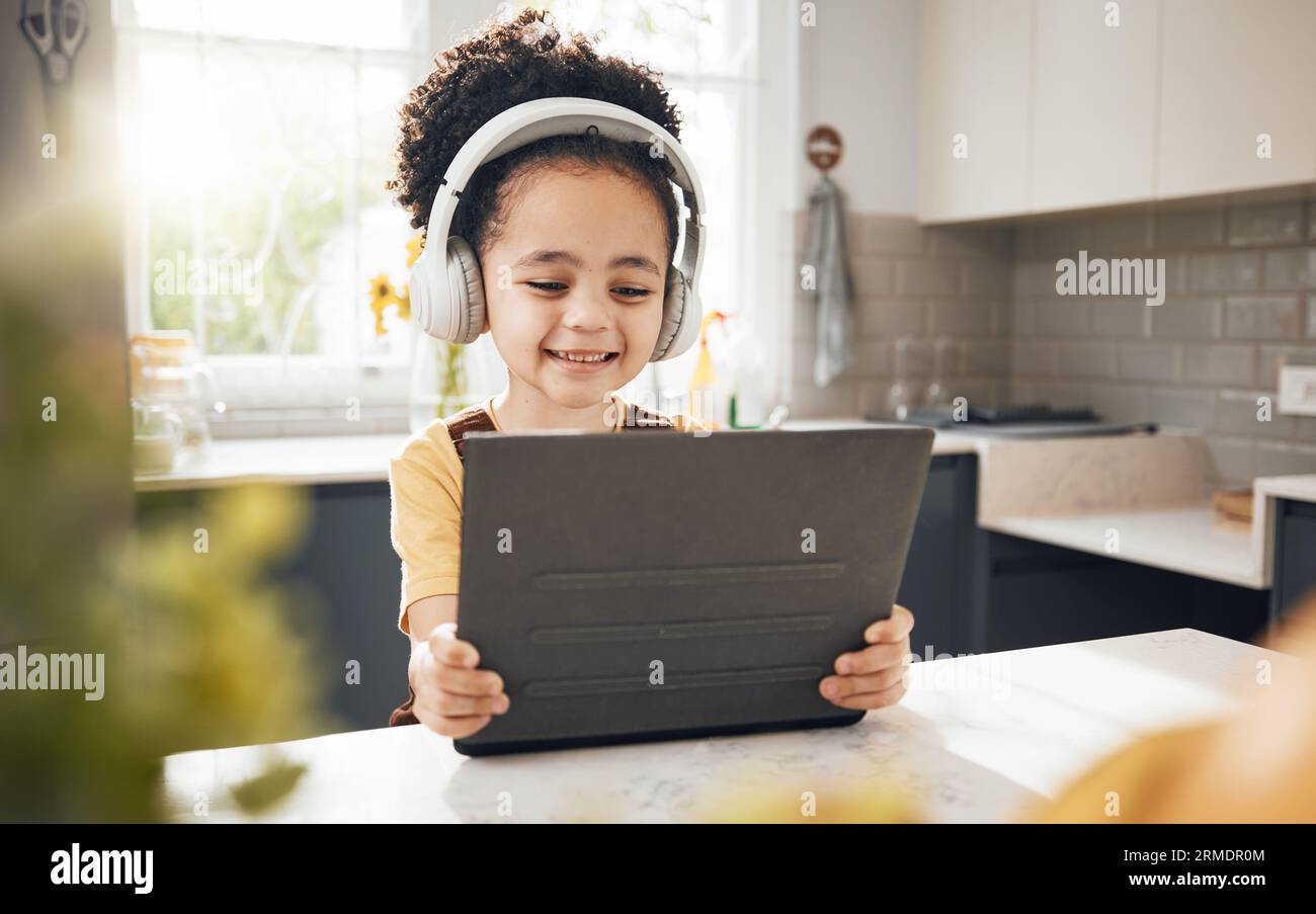 Tablet, headphones and child elearning in home, happy and online ...