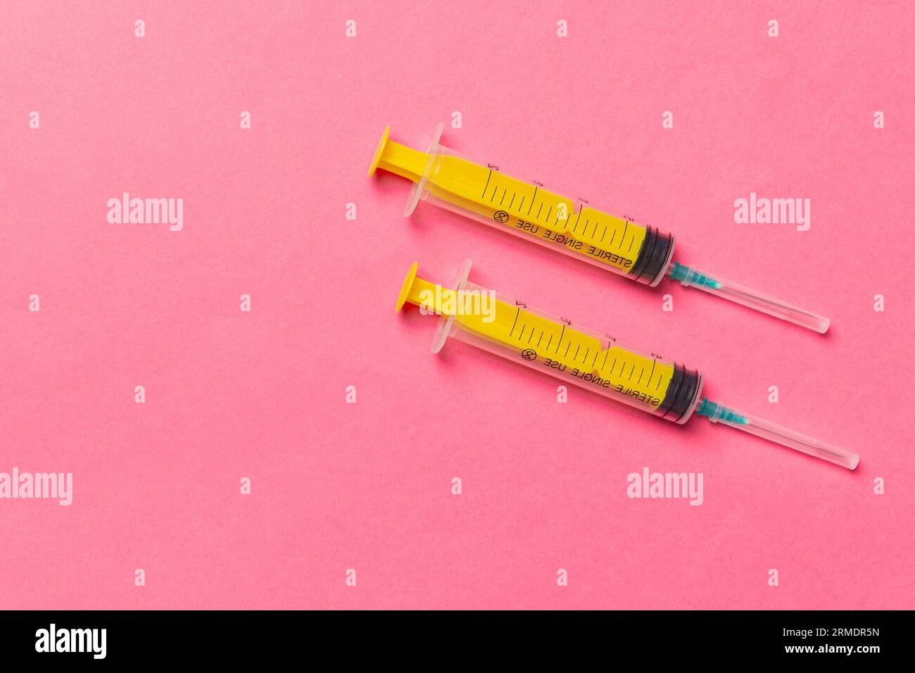 Top view of different syringes for injection on colorful background ...