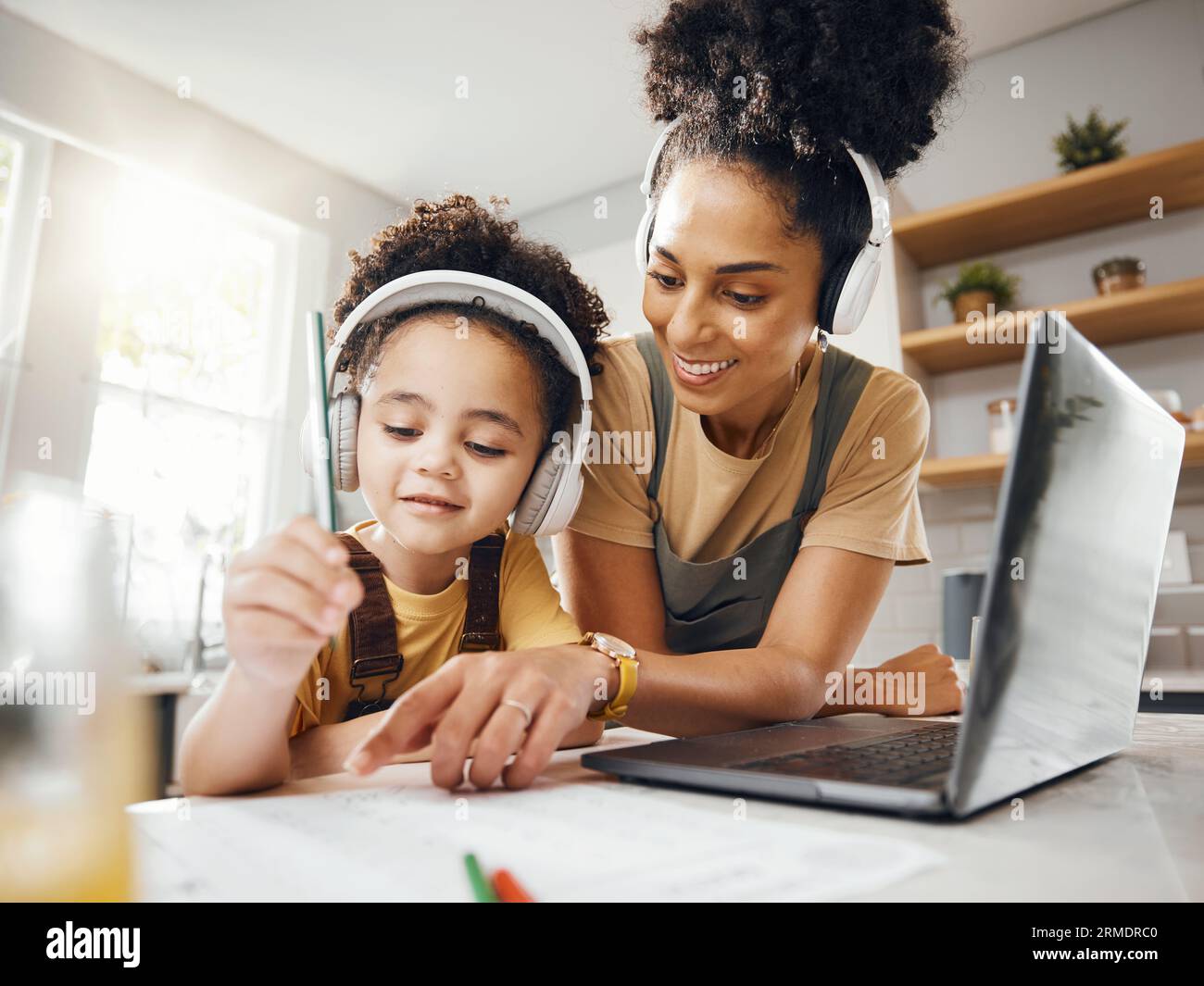 Elearning, mom and child in home with headphones, laptop and homework ...