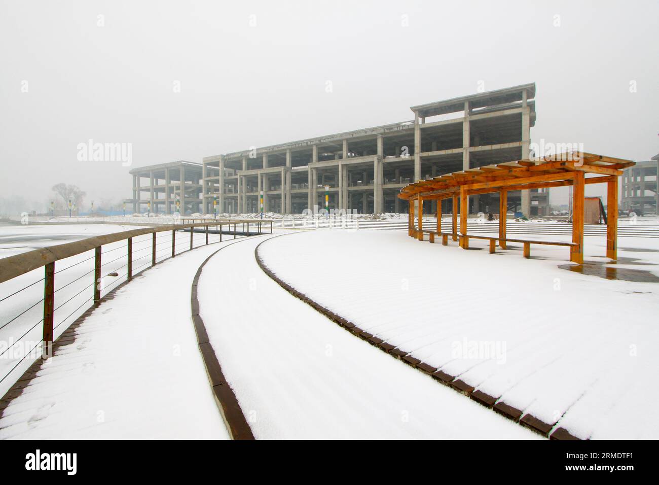 buildings and railing in the snow, at a construction site Stock Photo ...