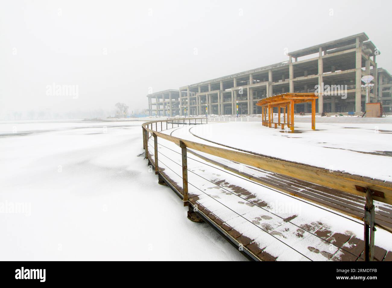 buildings and railing in the snow, at a construction site Stock Photo ...
