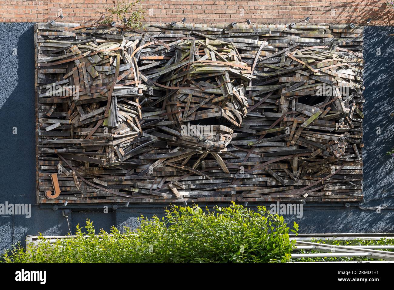 Wall mural of three faces made from wood planks, Skipper Street ...