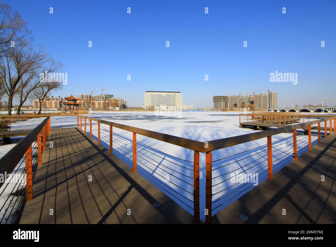 building and trestle bridge in river edge, in the winter, North China ...