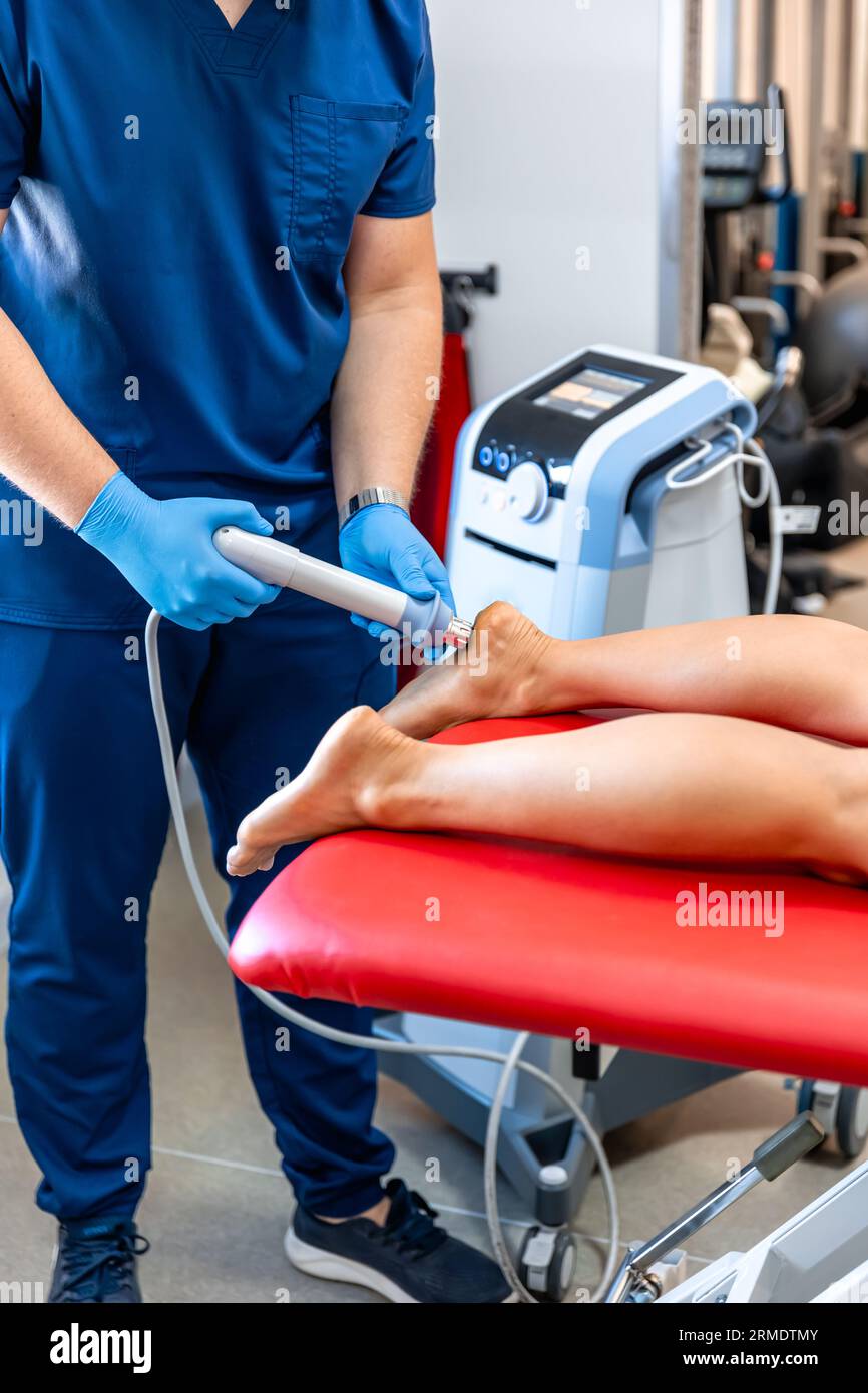 Patient getting non-surgical treatment with shock waves for plantar ...