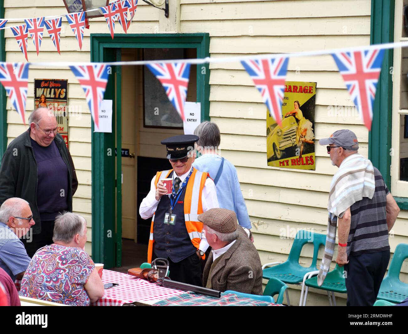 A helper dressed as a station master talking to visitors at Lady ...