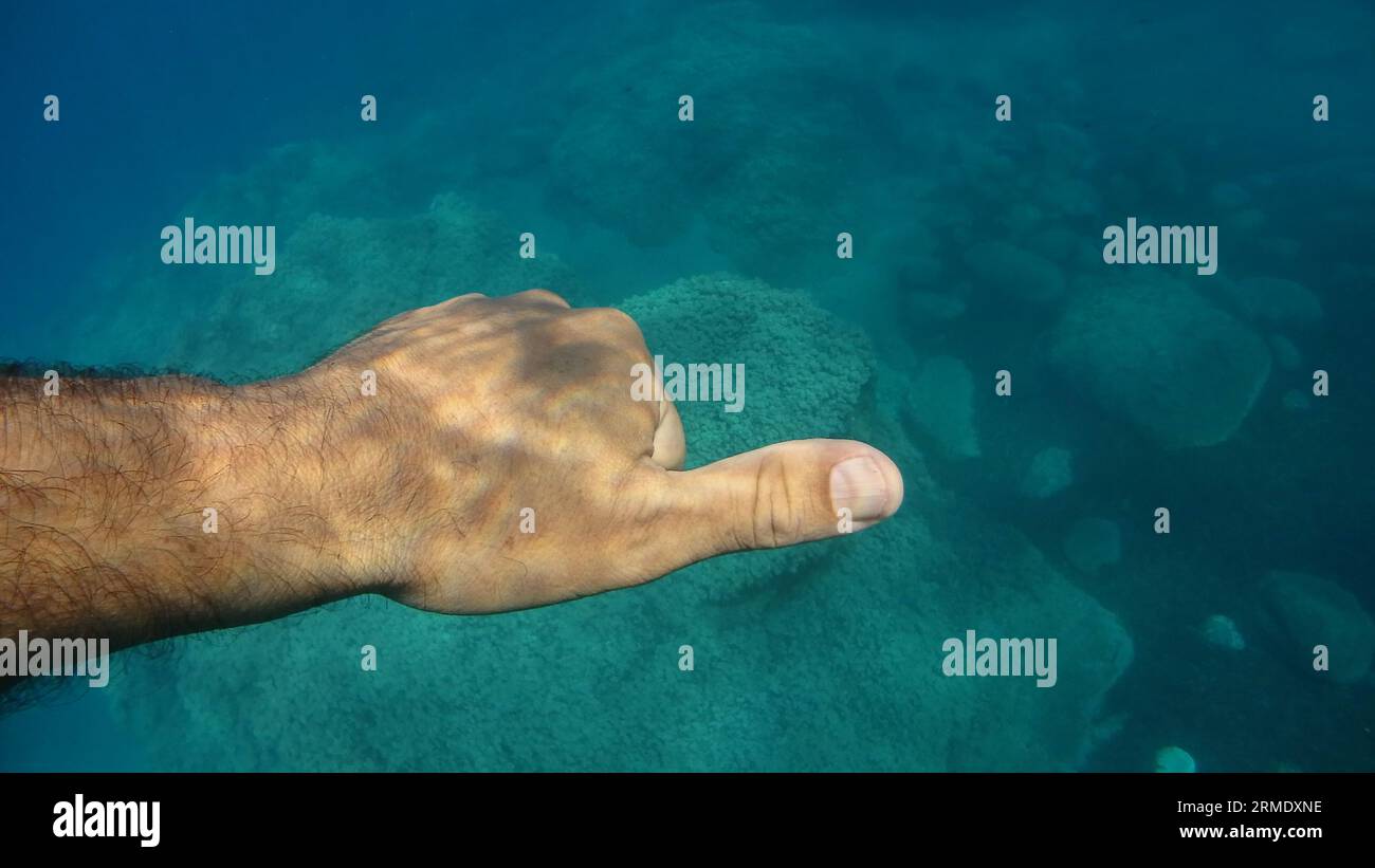 thumb up ok human hand underwater detail close up Stock Photo - Alamy