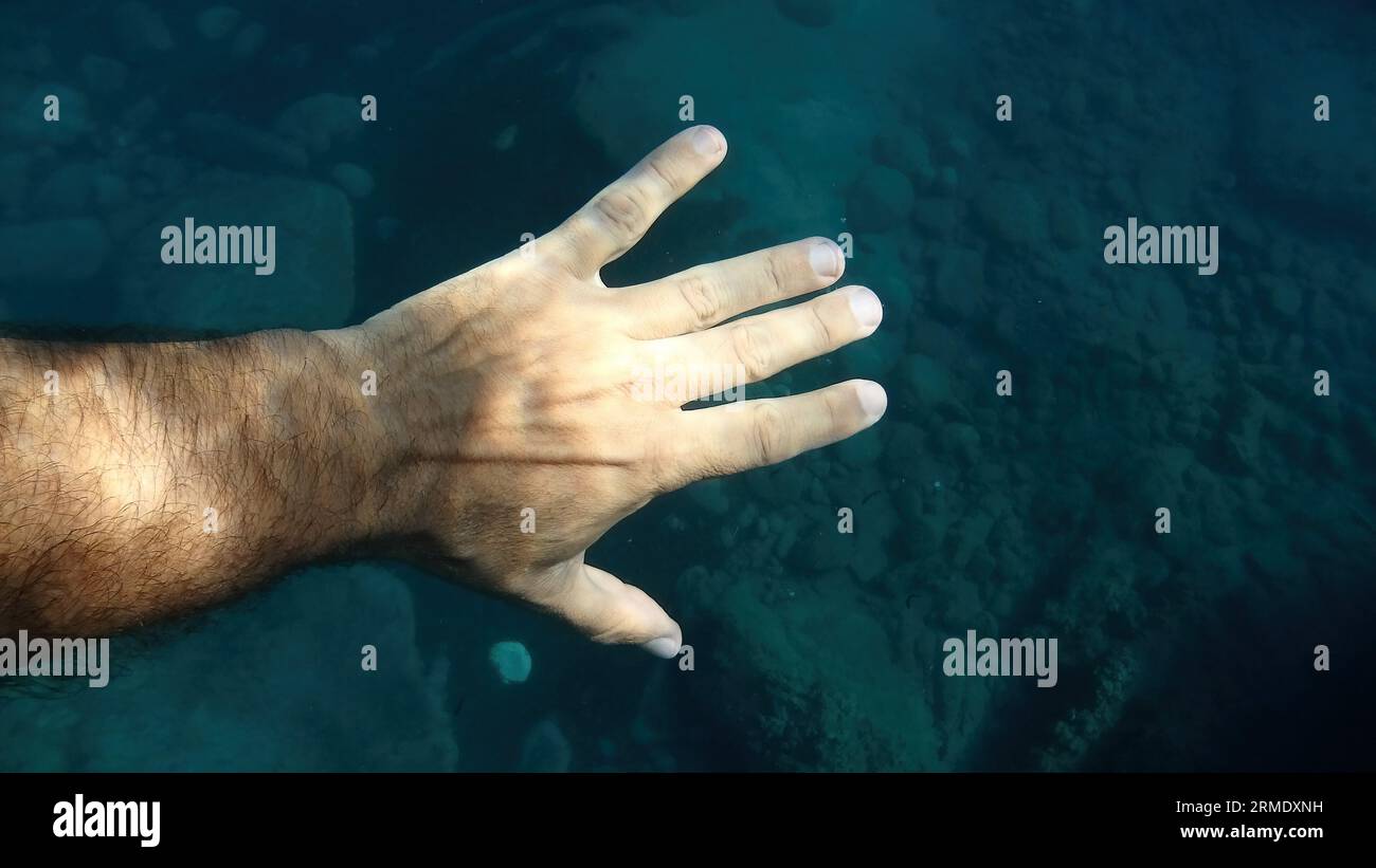 open palm human hand underwater detail close up Stock Photo - Alamy