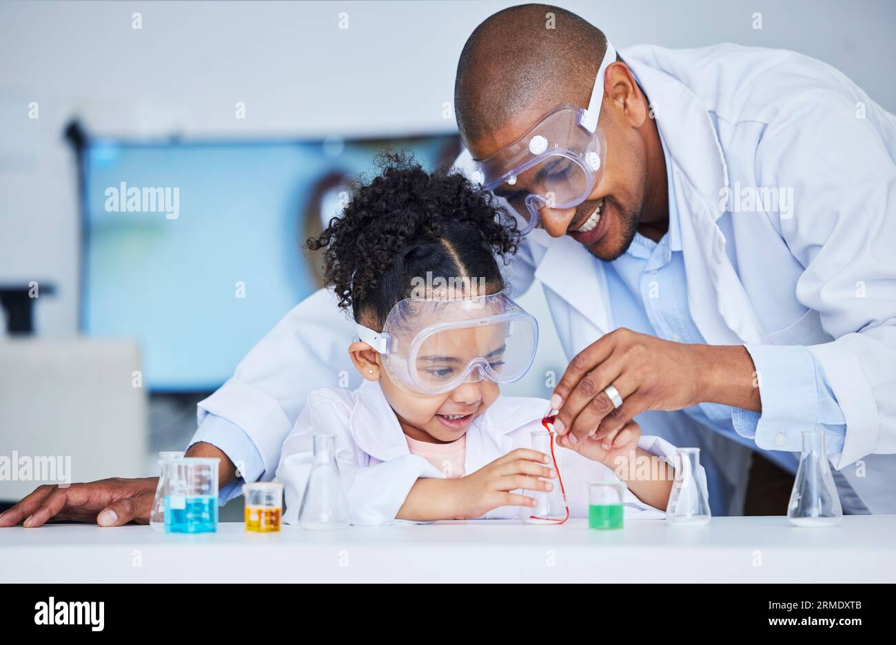 Science, help and a child and father with liquid for a chemistry ...