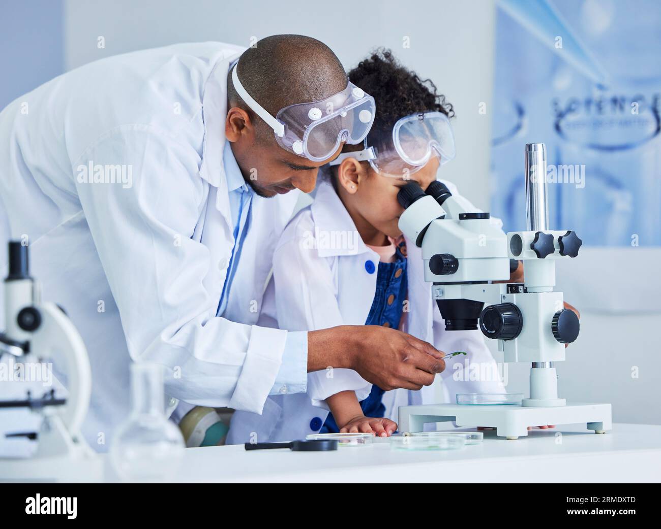 Lab test, father and child with microscope for learning, research and ...