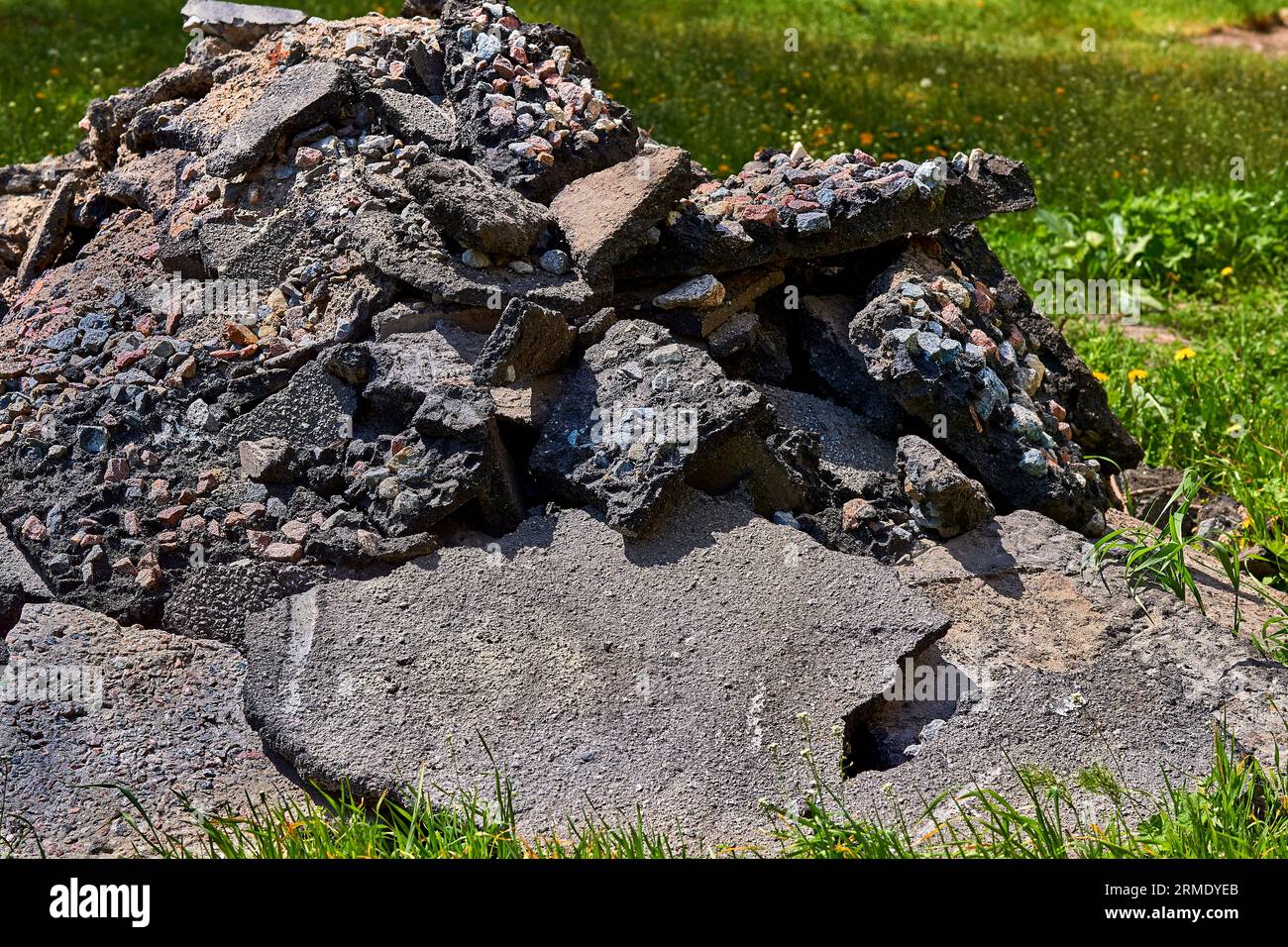 A pile of old broken asphalt with rubble left after the repair of the ...