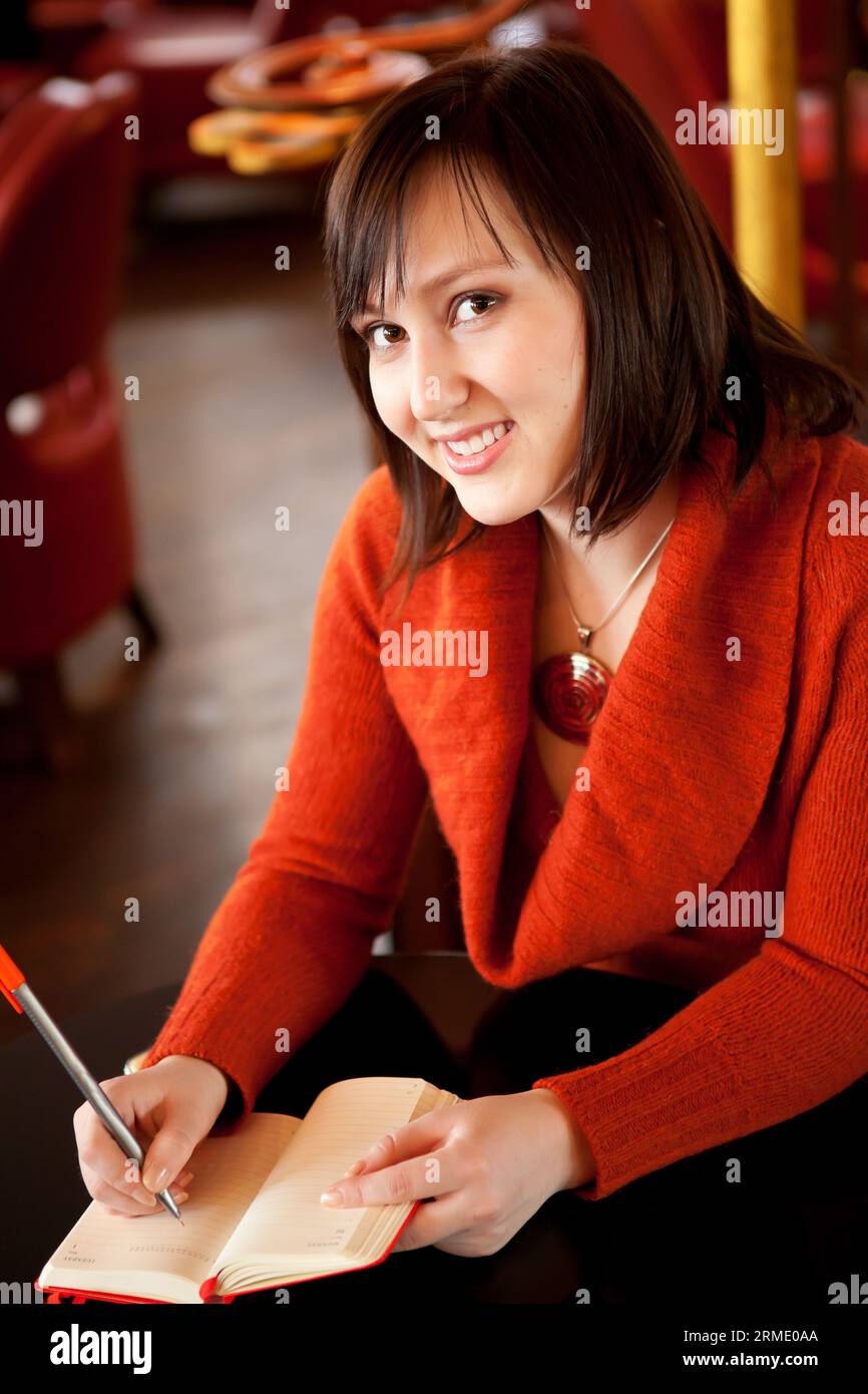 Beautiful girl with her personal organizer in a Parisian cafe Stock ...
