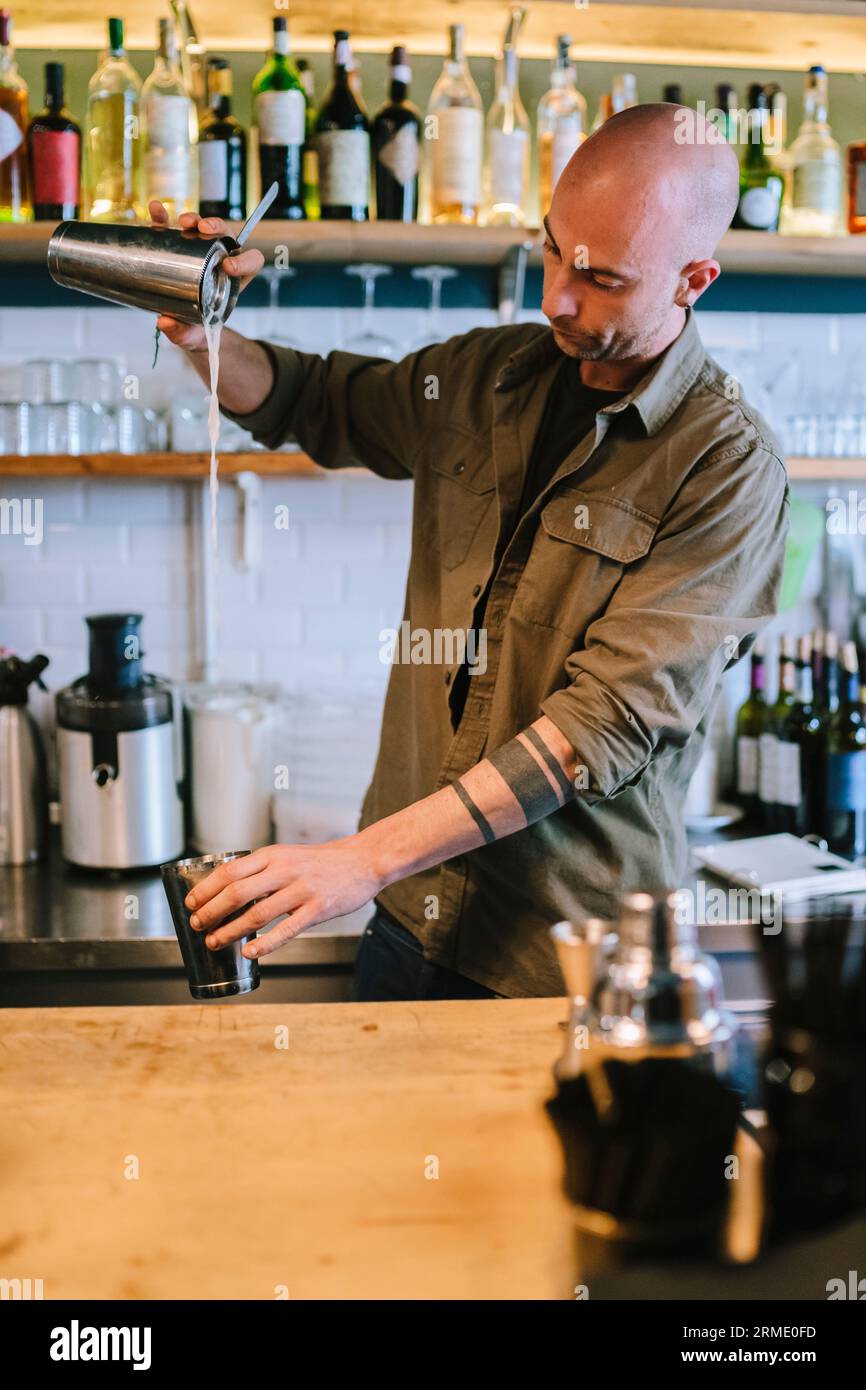 Young barman prepares an alcoholic cocktail in the bar Stock Photo - Alamy