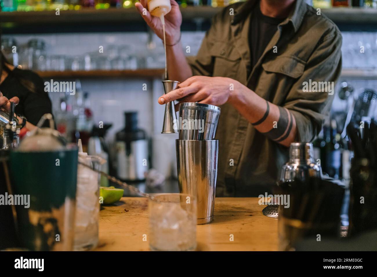 Young barman prepares an alcoholic cocktail in the bar Stock Photo - Alamy