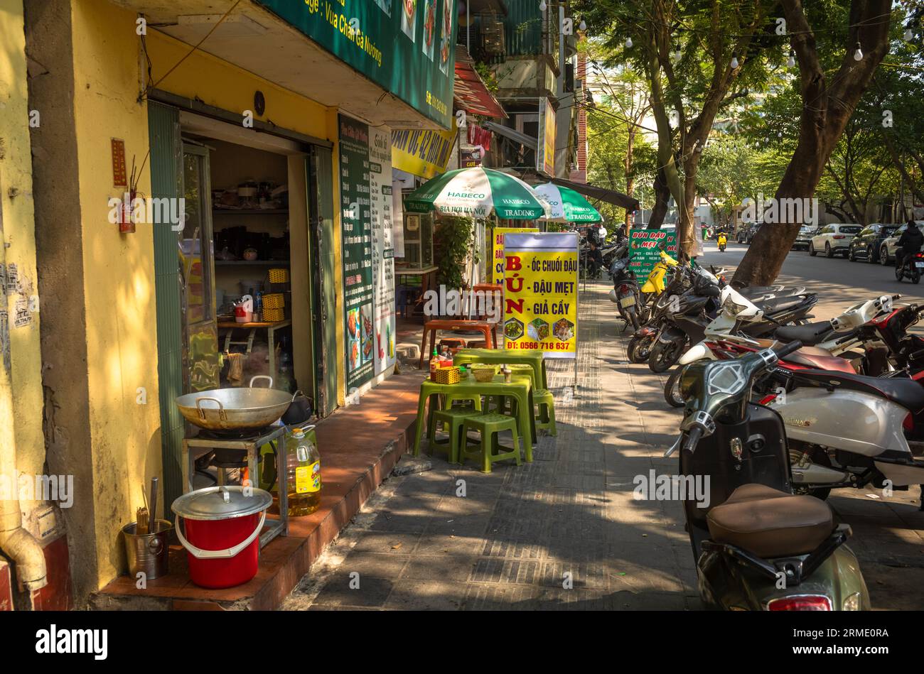 A traditional street food stall selling rice noodles with snails or ...